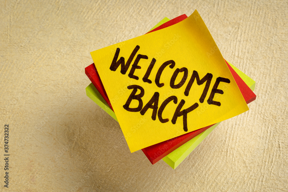 welcome back - handwriting on a sticky note, greetings and business ...