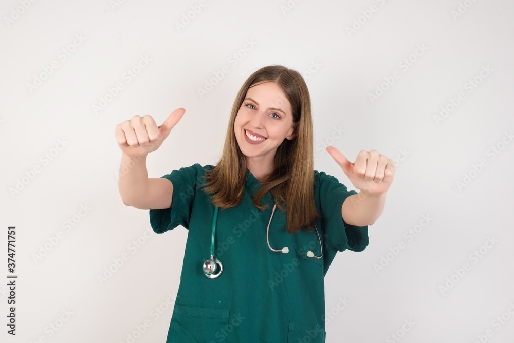 Female doctor wearing a green scrubs and stethoscope approving doing ...
