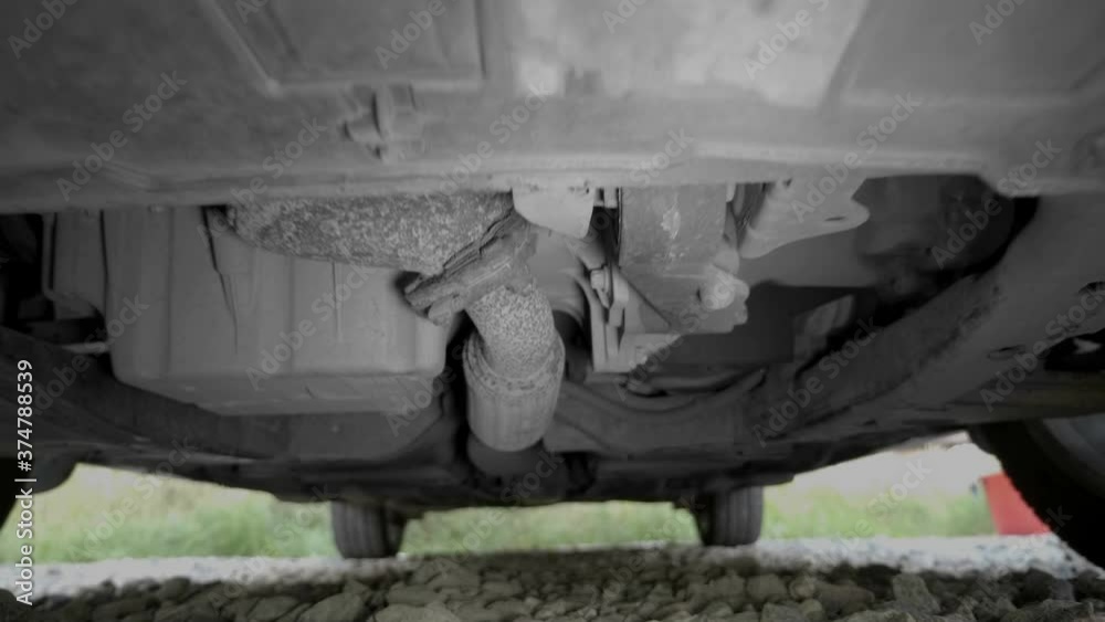 View of the car under the bottom. The car is driving, we see the lower ...
