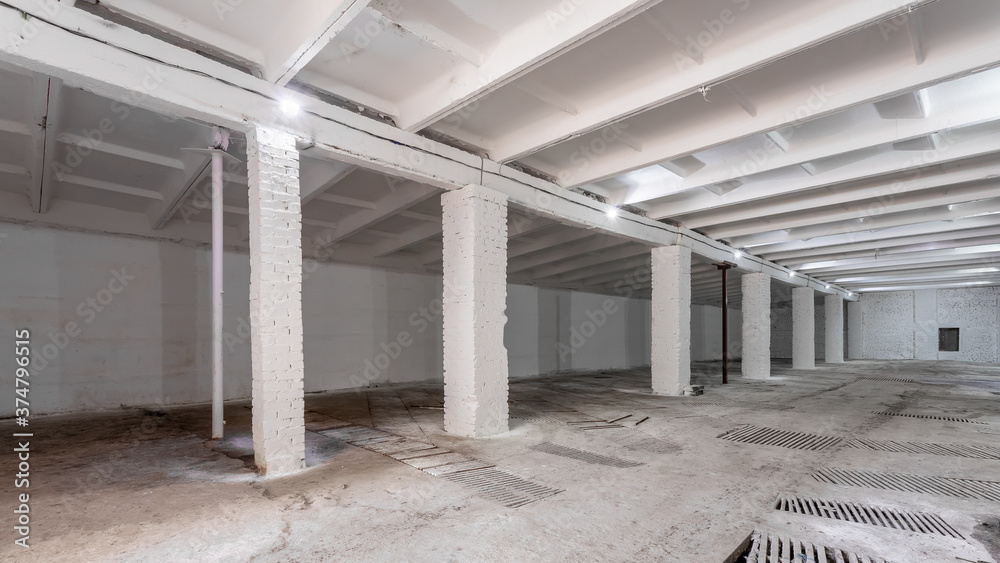 Industrial building interior with white brick walls, concrete floor and ...