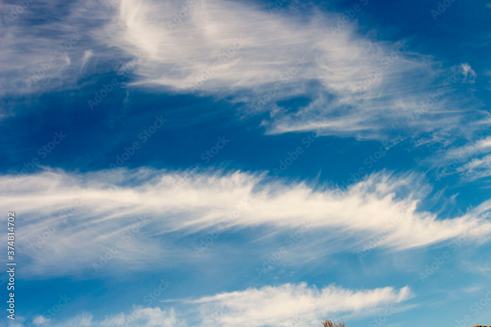 High white wispy cirrus clouds with cirro-stratus in the blue ...