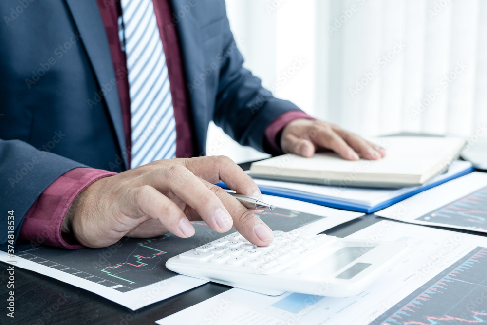 Hand of businessmen are planning business investments related to shares ...