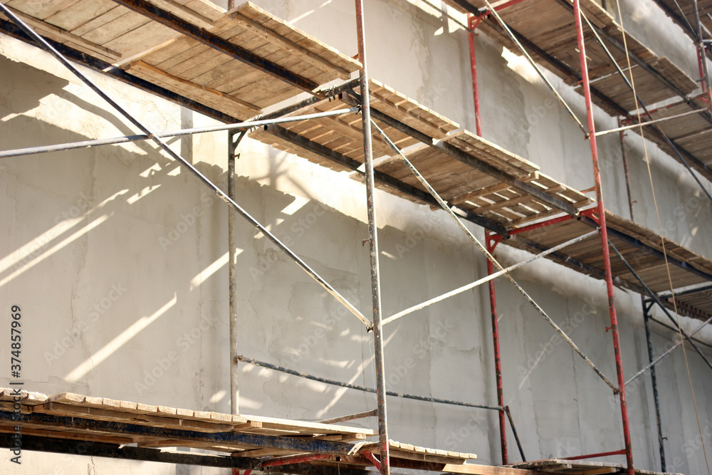 scaffolding installed near a multi-storey building, wall insulation ...