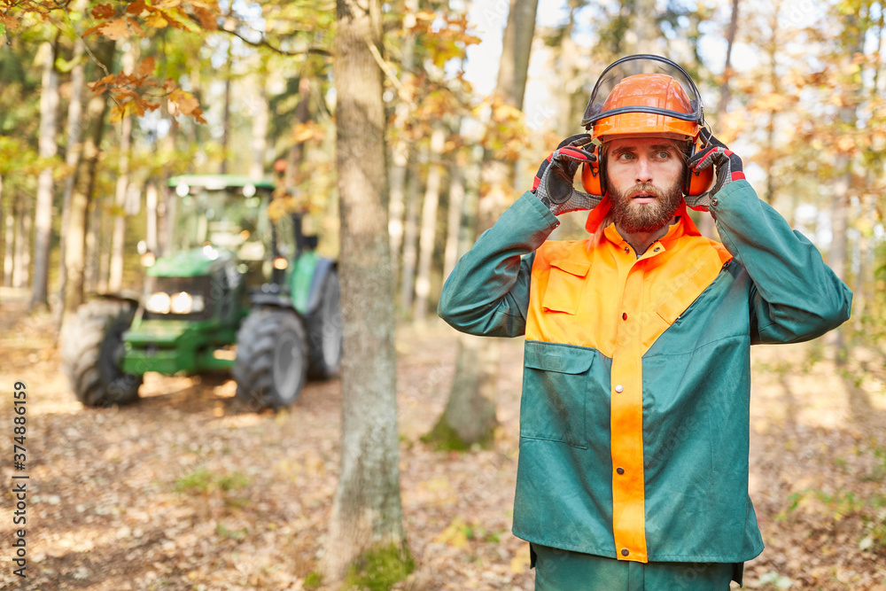 Forest worker with safety helmet and ear protection Stock Photo | Adobe ...