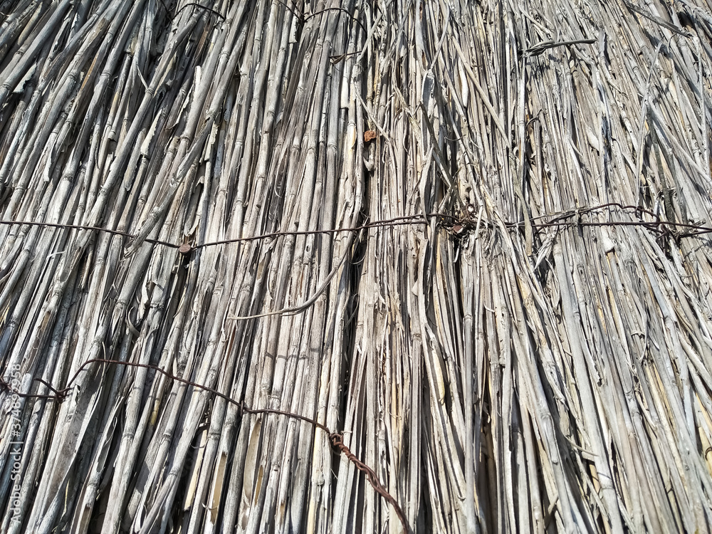 Fragment of an old thatched roof. Thatch roof background, hay or dry ...