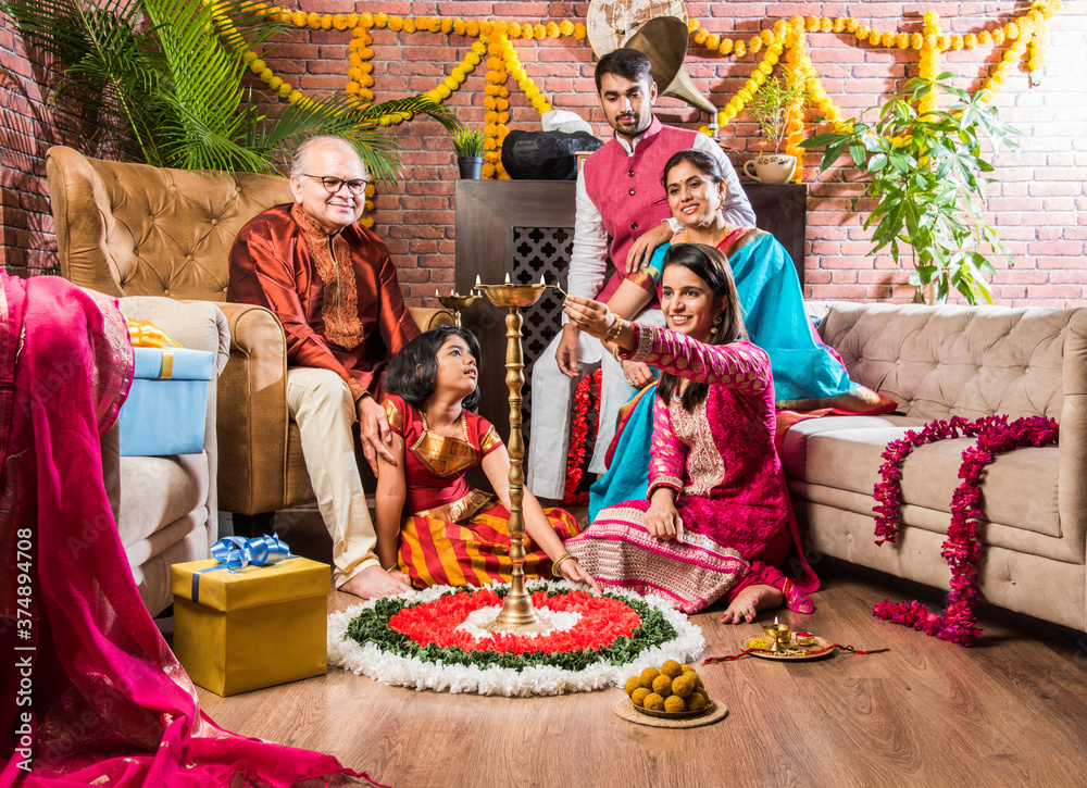 Happy Indian family performing Puja or pooja on Ganesh Chaturthi ...