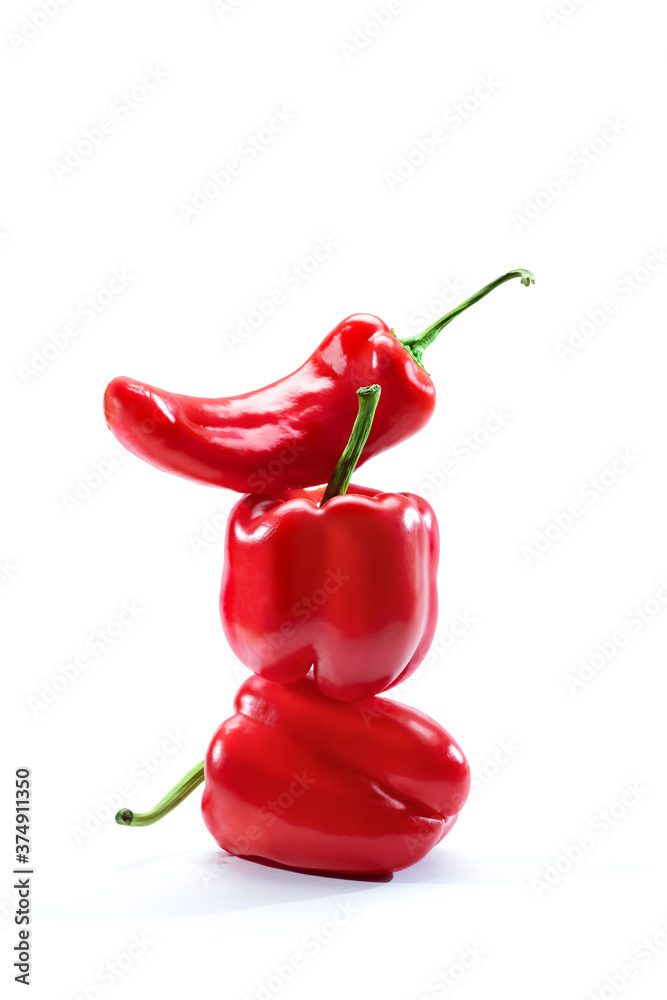Tower of three red pepper isolated on white background. Two sweet bell ...