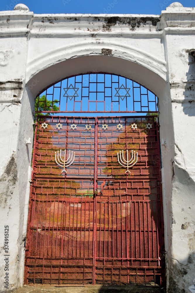 An iron gate of an old destroyed synagogue with David star and menorah ...