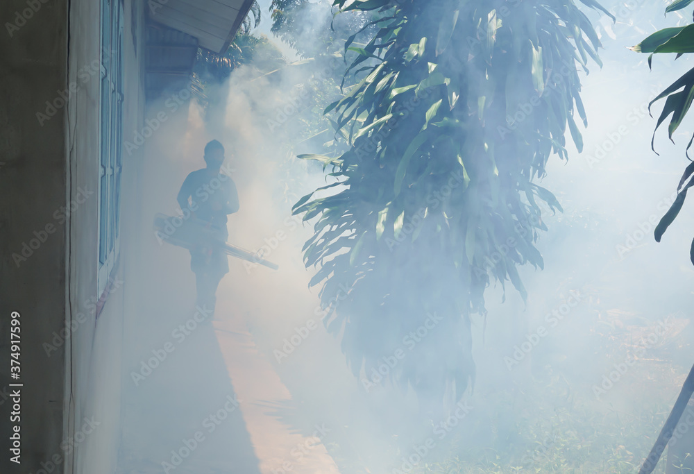 Blurred humans work on fogging mosquitoes to prevent the spread of ...