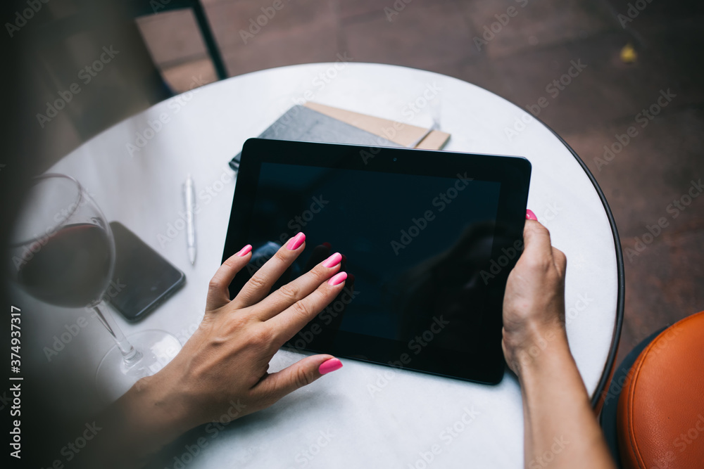 Female touching with finger on mock up display of modern touch pad ...