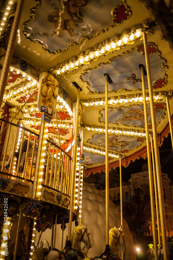 Children's Carousel at an amusement park in the evening and night ...