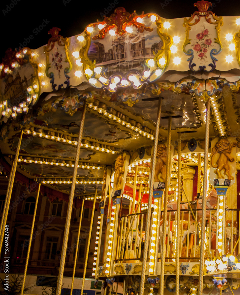 Children's Carousel at an amusement park in the evening and night ...