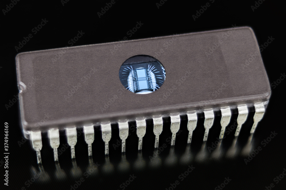 Erasable programmable read-only memory. EPROM chip on black background ...