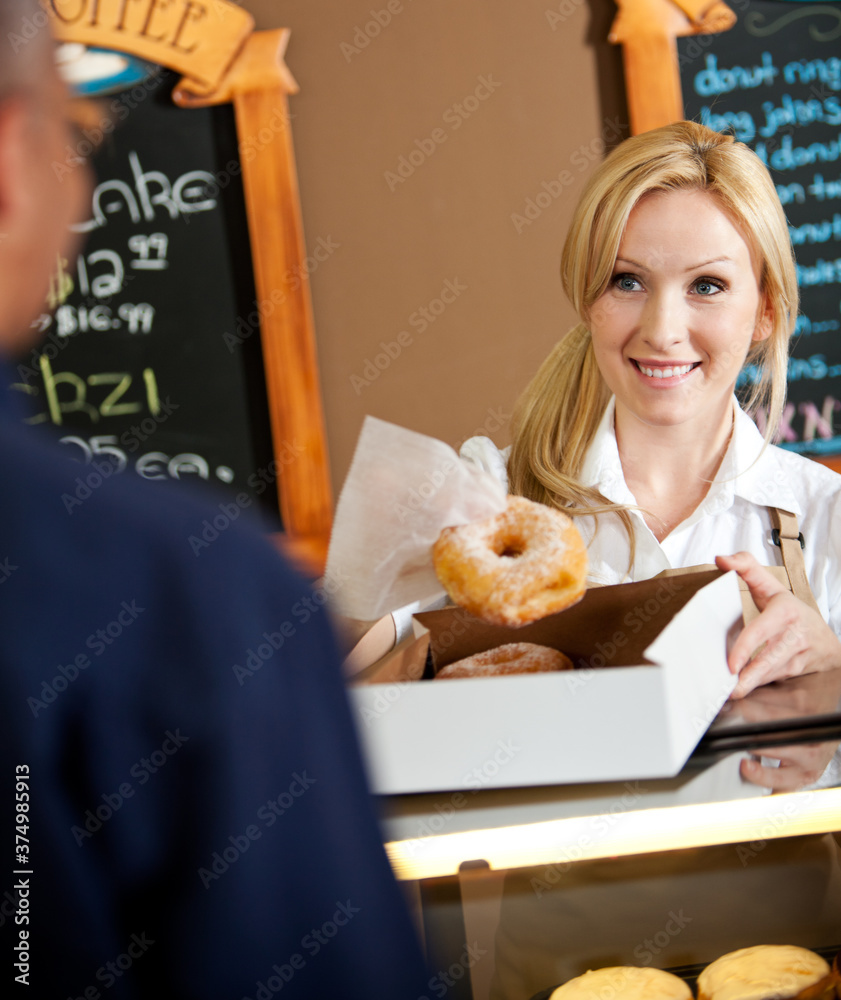 Bakery: Employee Boxing Up Donuts for Customer Stock-Foto | Adobe Stock