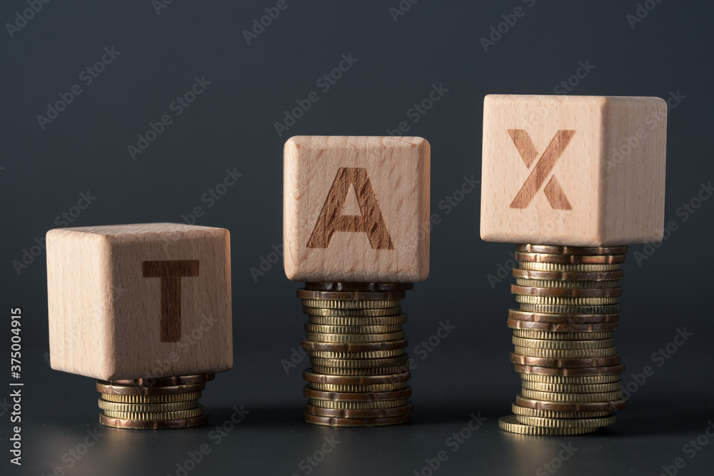 Tax concept, wooden block with text on stacked coins Stock Photo ...