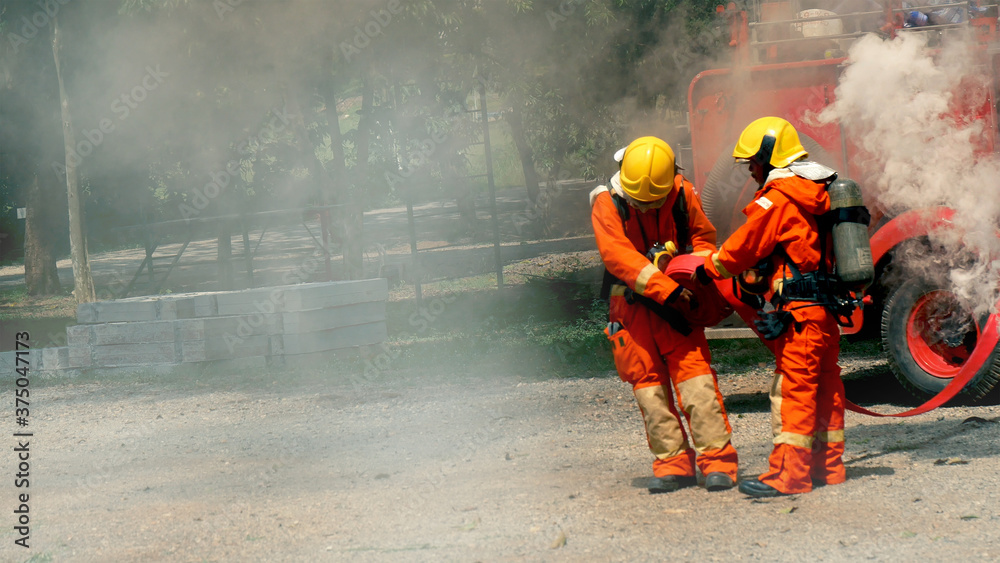Firefighter fighting with flame using fire hose chemical water foam ...