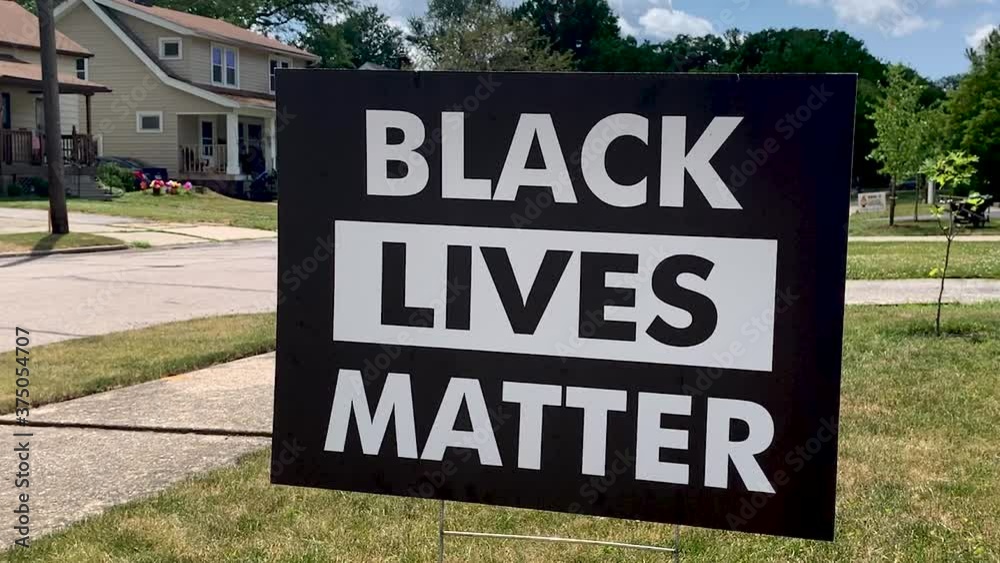 Black Lives Matter sign in the front yard of a suburban city home. BLM ...