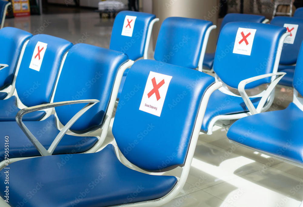 New normal, X symbol sticker placed on a chairs, distance for one seat ...