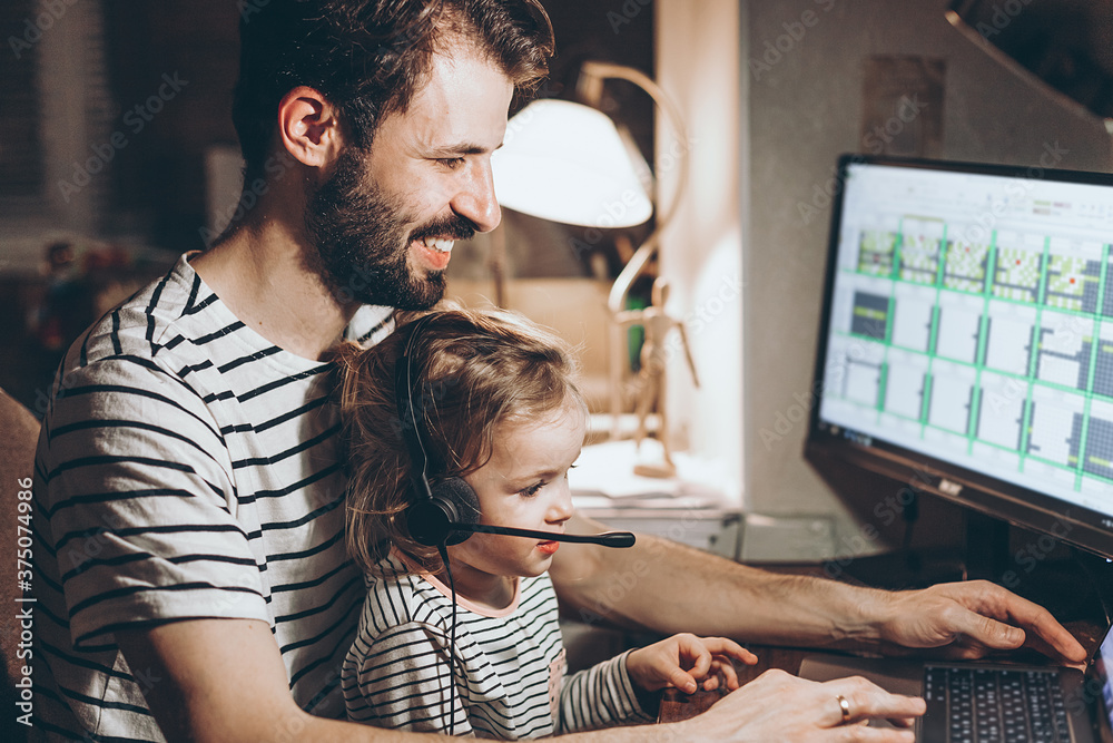 Father and daughter are working on a laptop. businessman working from ...