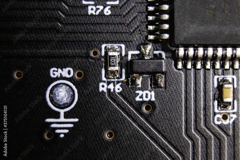 artistic close up for ground test point next to microcontroller ...