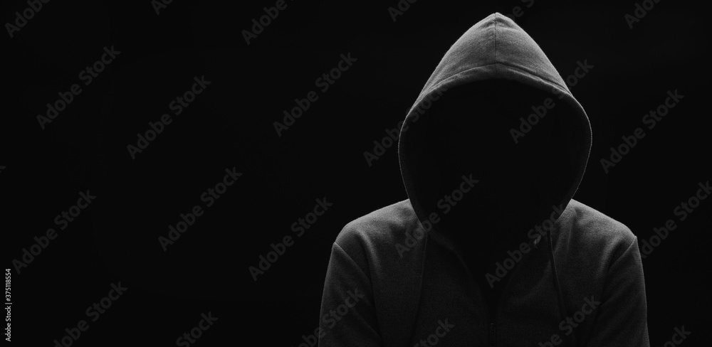 dark mysterious man in a hoodie is hiding his face, hacker, anonymous ...