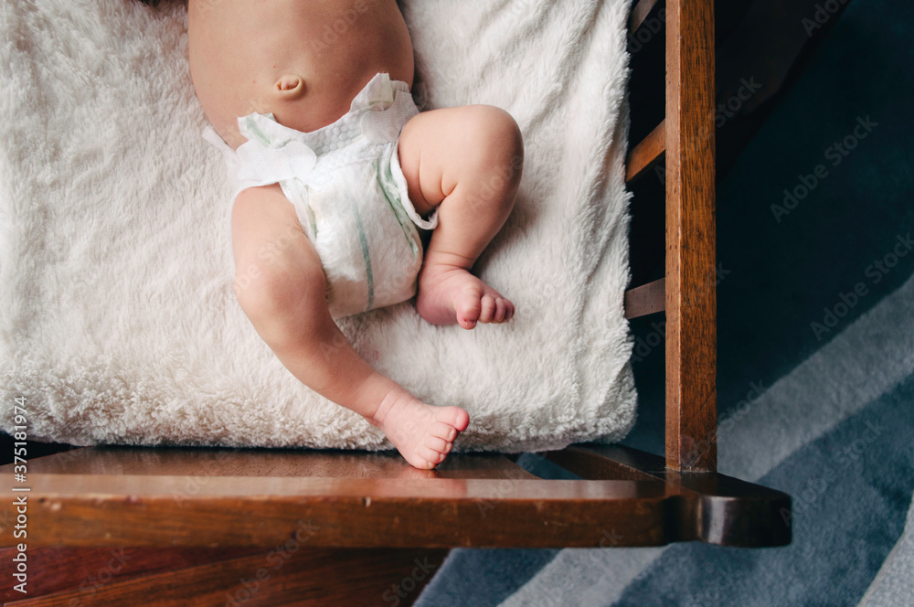 baby's legs and feet in a cradle Stock Photo | Adobe Stock