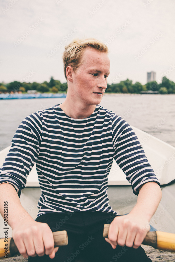 Young man rowing Stock Photo | Adobe Stock