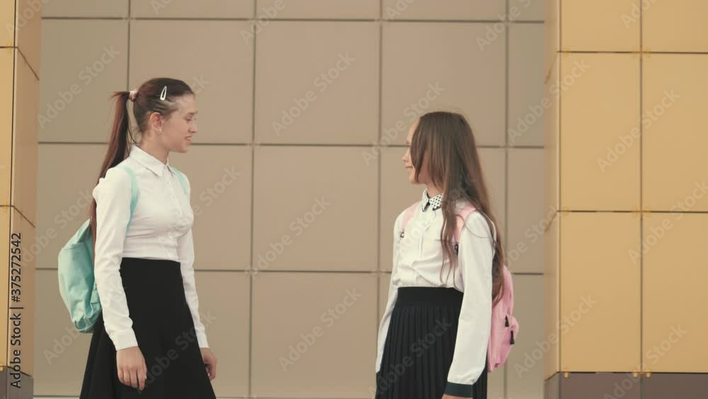 Greets classmates without contact with help of an elbow. girls ...