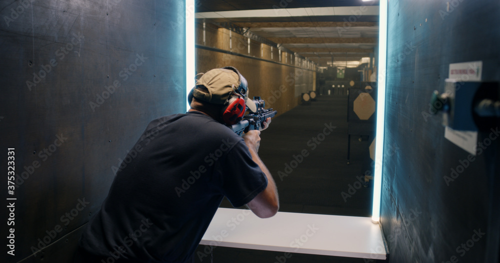 Professional shooter firing at target Stock Photo | Adobe Stock