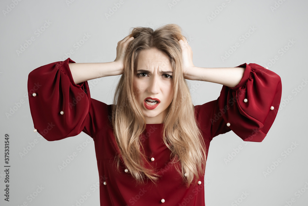 Photo of girl with long blonde hairs holding hands on head. Problems ...