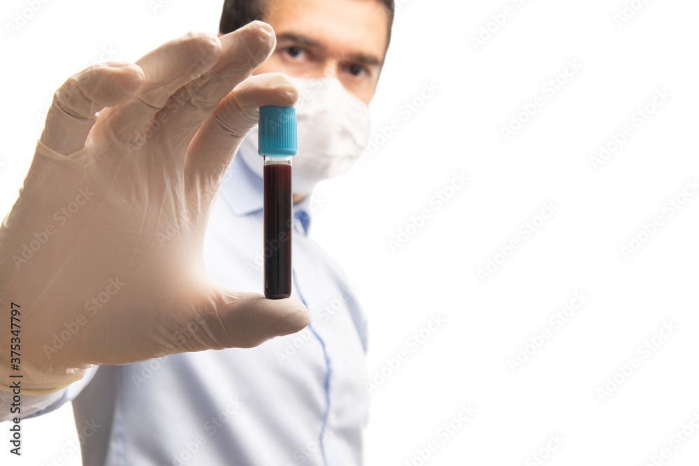 Young caucasian scientist holding tube with blood sample (focus is on ...