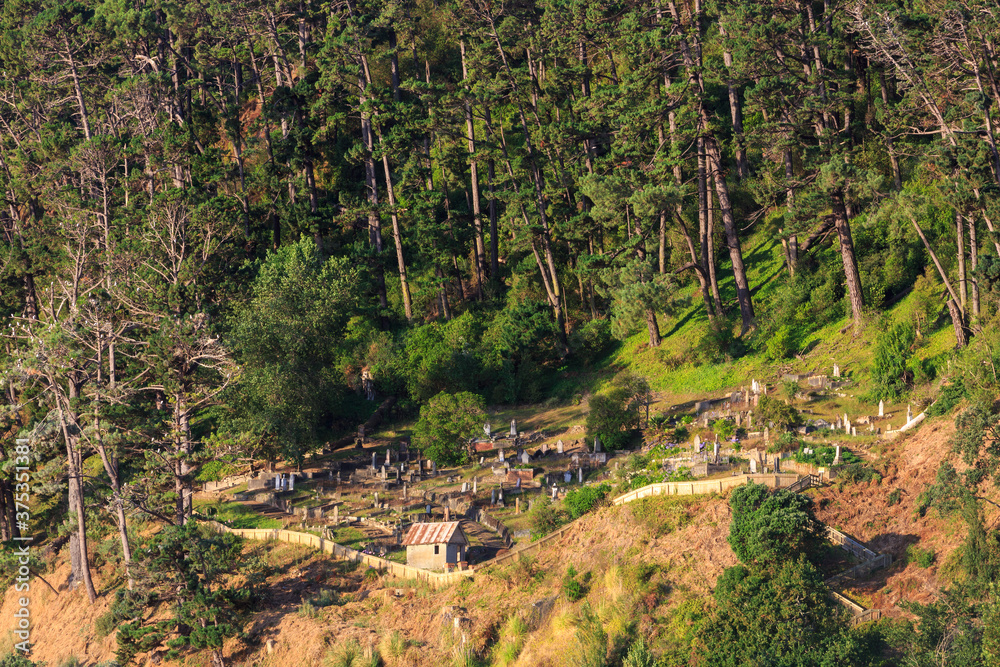 The historic Tararu cemetery near Thames, New Zealand, perched on a ...