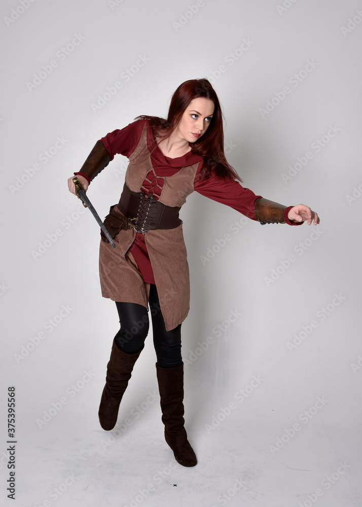 Full length portrait of girl wearing medieval costume. Standing pose ...