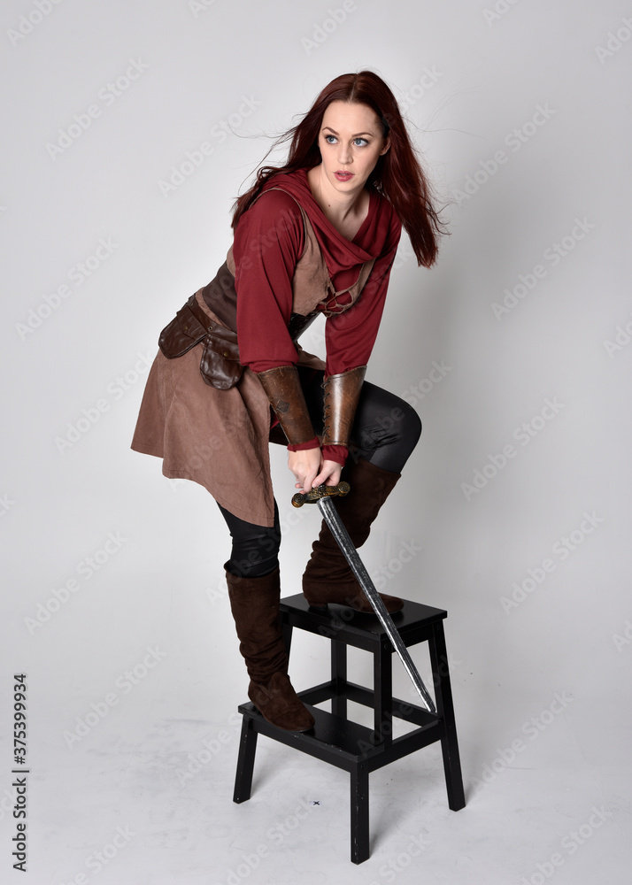 Full length portrait of girl wearing medieval costume. Standing pose ...