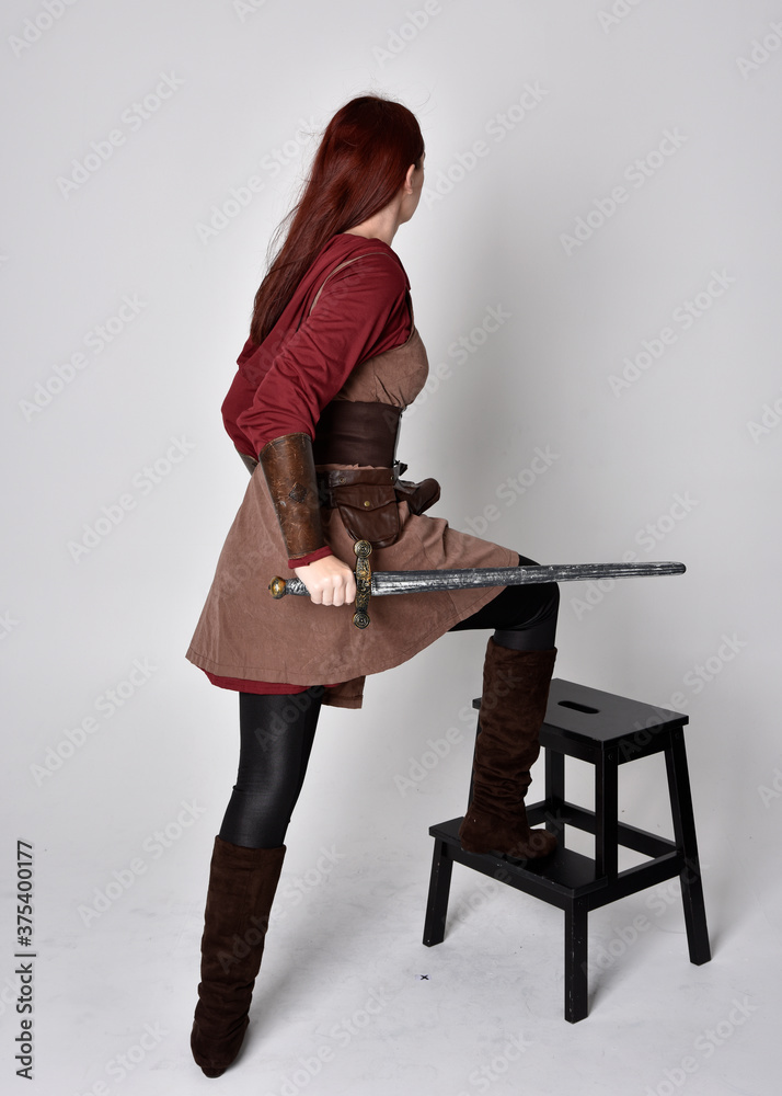 Full length portrait of girl wearing medieval costume. Standing pose ...