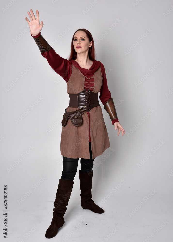 Full length portrait of girl wearing medieval costume. Standing pose ...