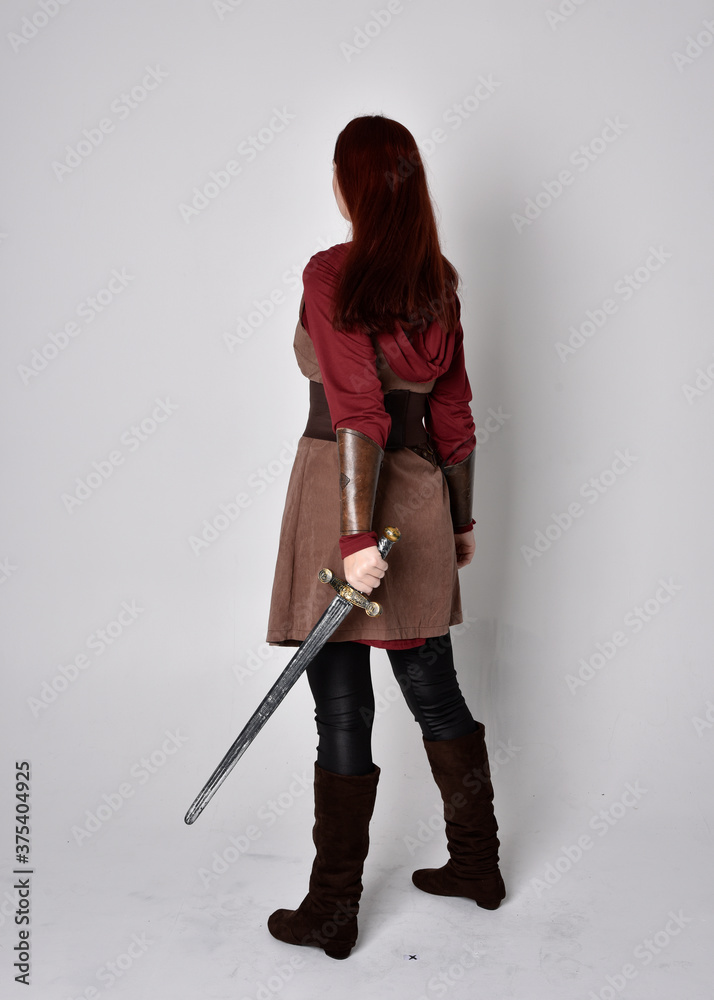 Full length portrait of girl wearing medieval costume. Standing pose ...
