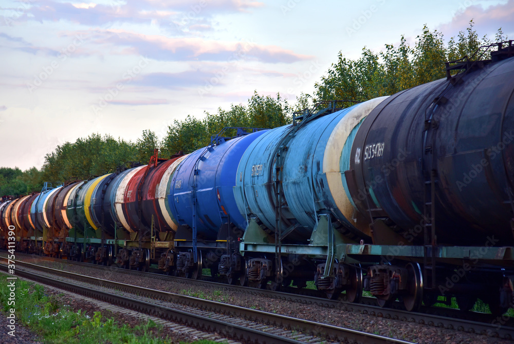 Freight train with petroleum tank cars on railroad. Rail cars carry oil ...