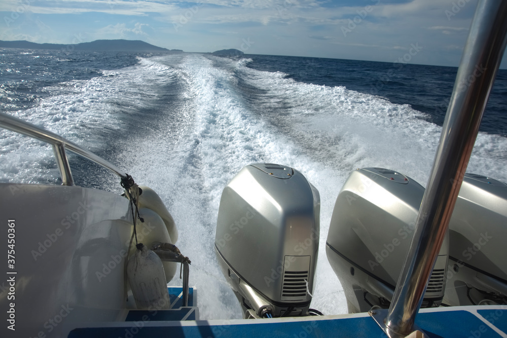 Boat on the sea to fast moving boat by three motor engine. Splash wave ...