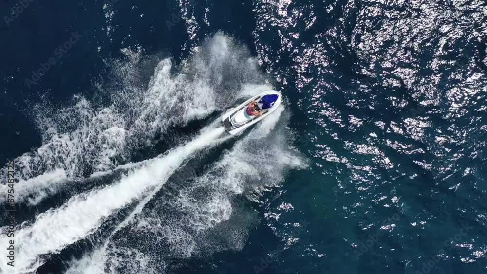Aerial video of woman operating jet ski water craft making extreme ...