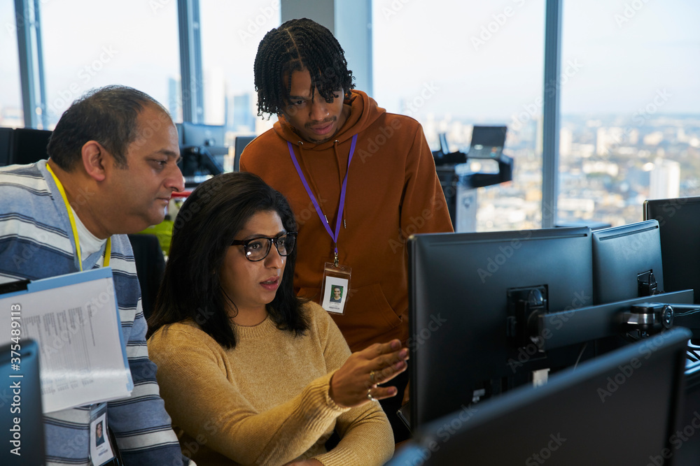 Business people talking at computer in office Stock Photo | Adobe Stock