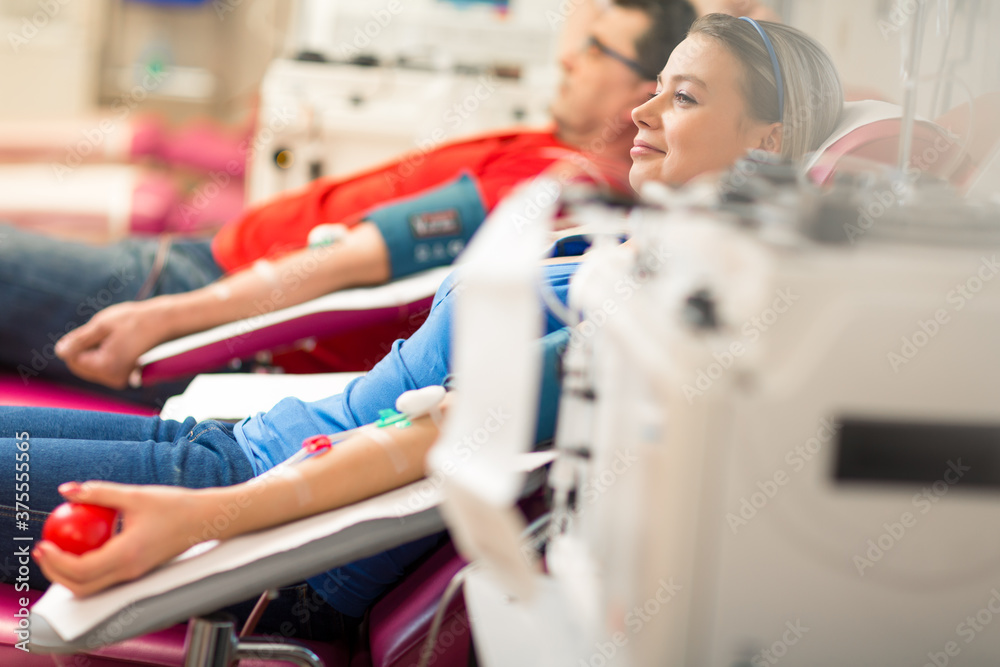 Young woman giving blood in a modern hospital (color toned image) Stock ...