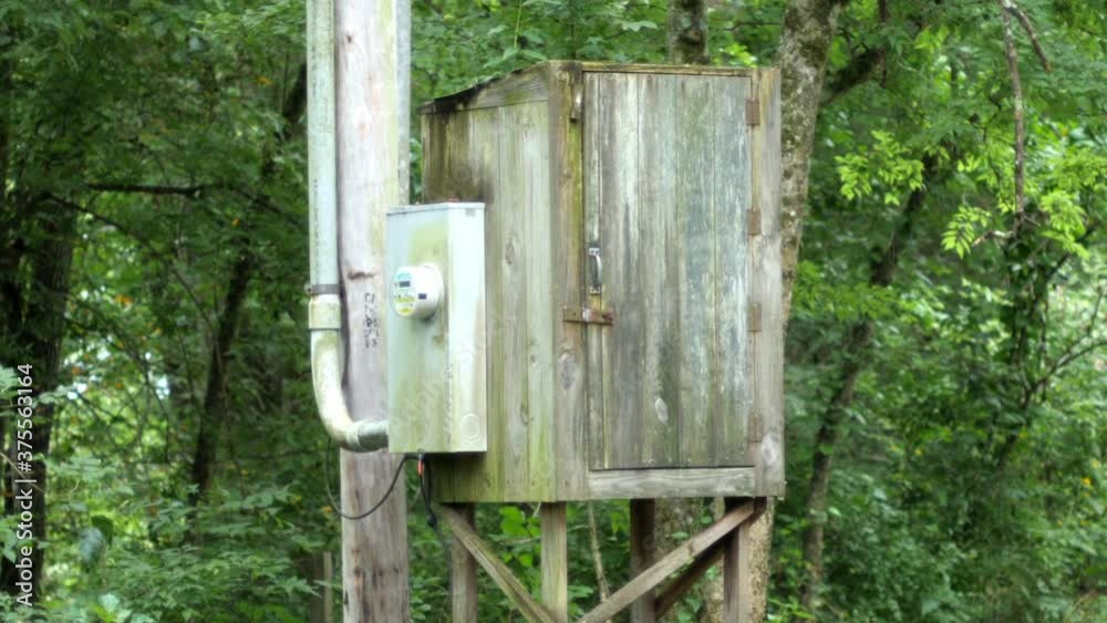 Old antique rustic wooden power box for bringing electricity to a rural ...