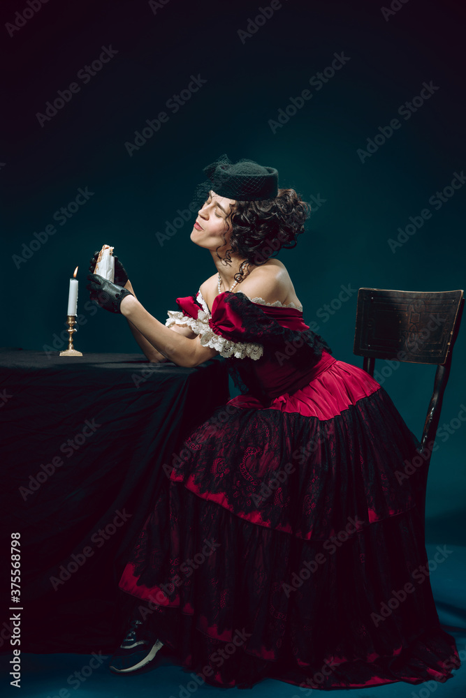Happiness. Young woman as Anna Karenina isolated on dark blue ...