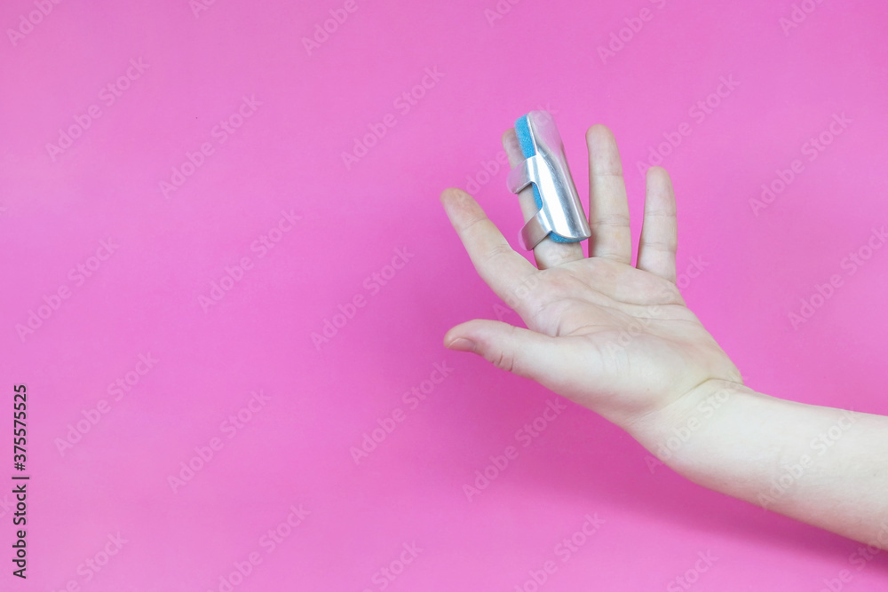 Blue aluminum finger splint with locks on the broken middle finger ...