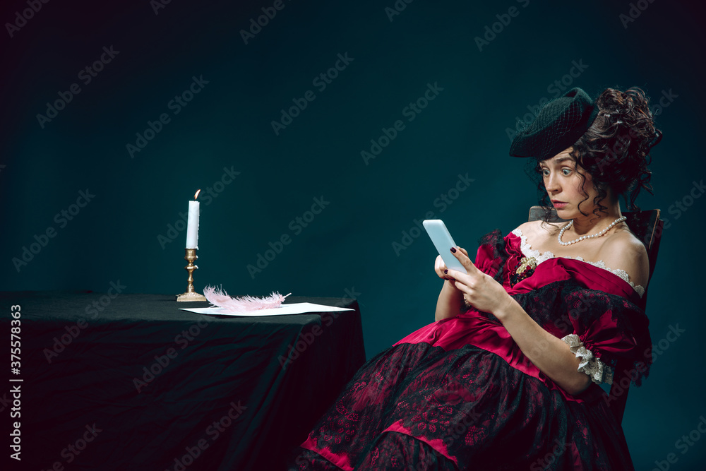 Shocking news. Young woman as Anna Karenina isolated on dark blue ...