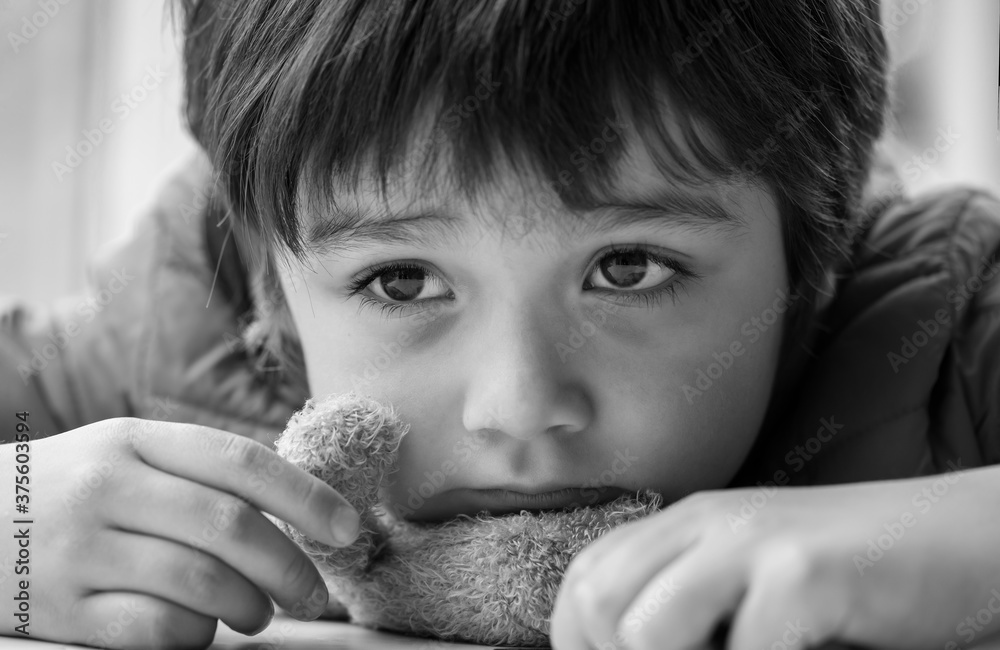 Black and white photo of Kid with bored face,Lonely boy putting his ...