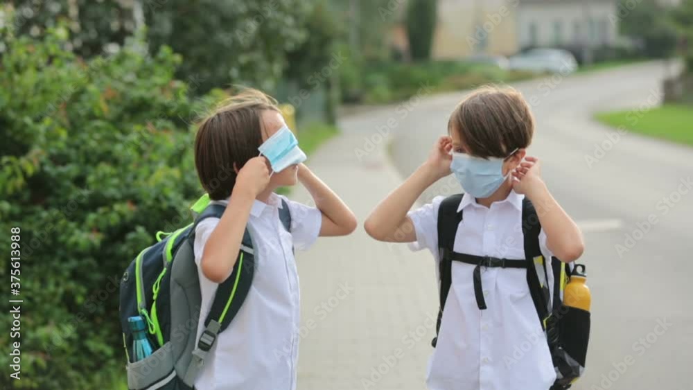 School children, boys, going back to school after the summer vacation ...
