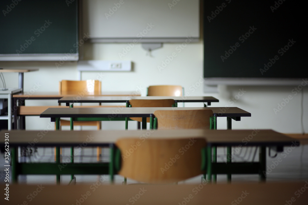 School furniture and chalkboards in an empty classroom shortly before ...