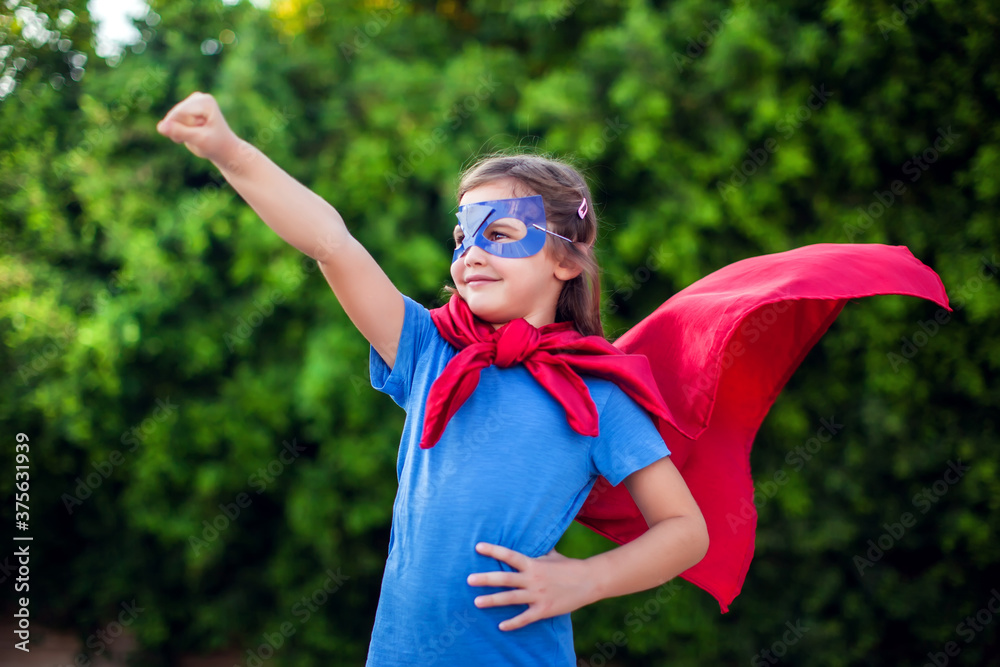 Superhero kid against green background outdoor. Childhood, success and ...